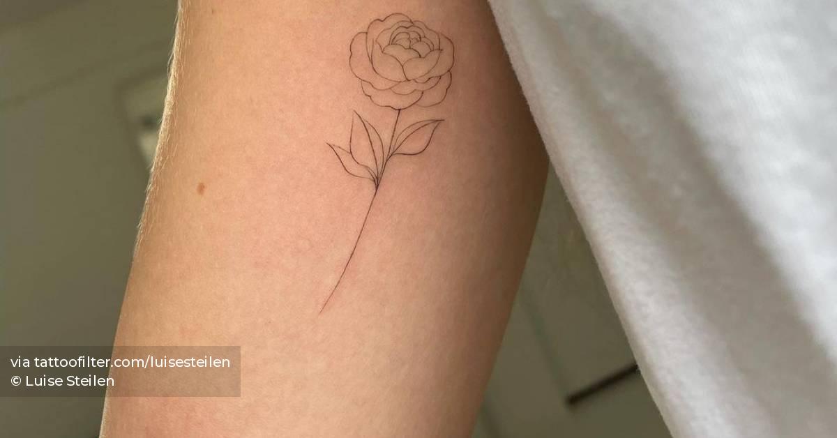 Fine line rose tattoo on the inner arm.