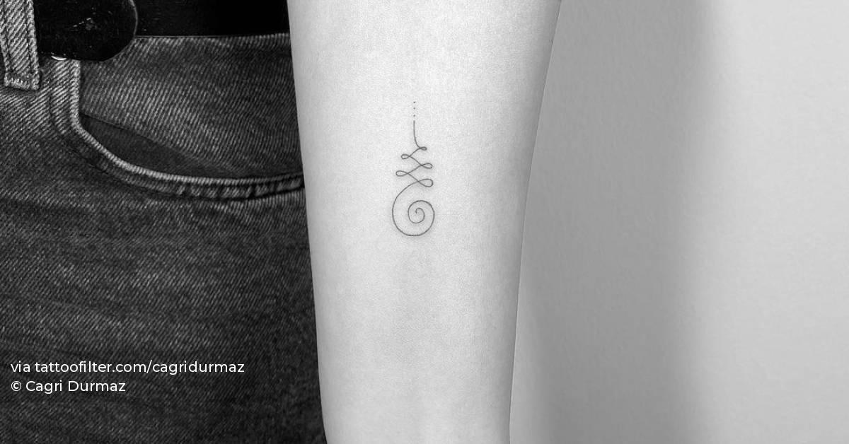 FIne line unalome tattoo on the inner forearm.
