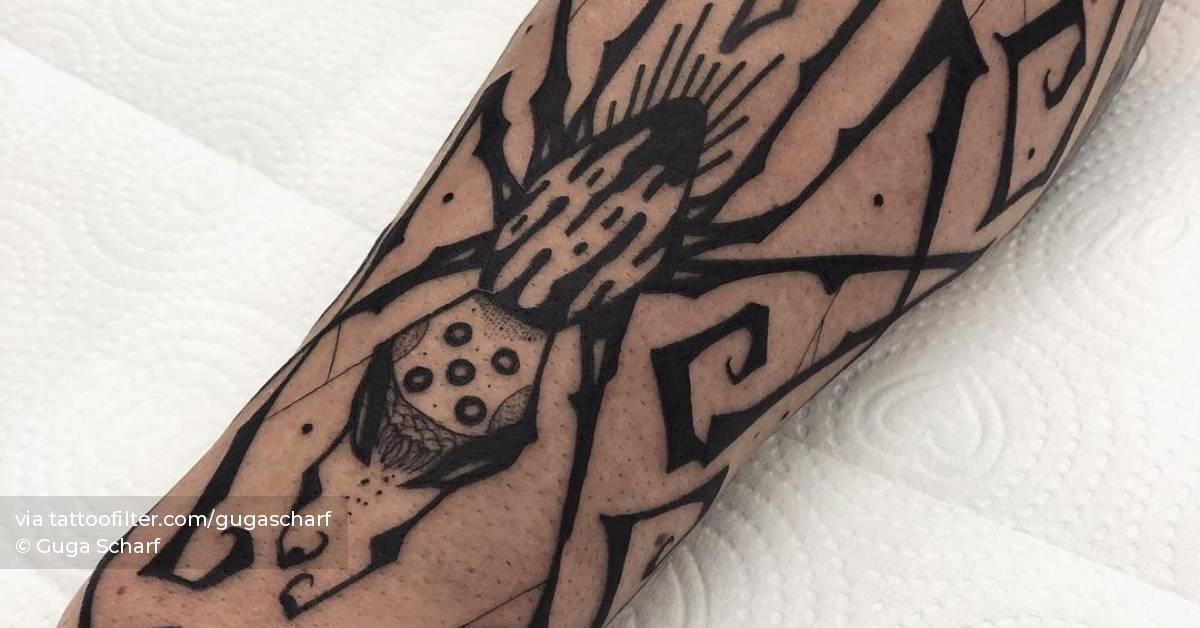 Blackwork spider tattoo on the forearm.