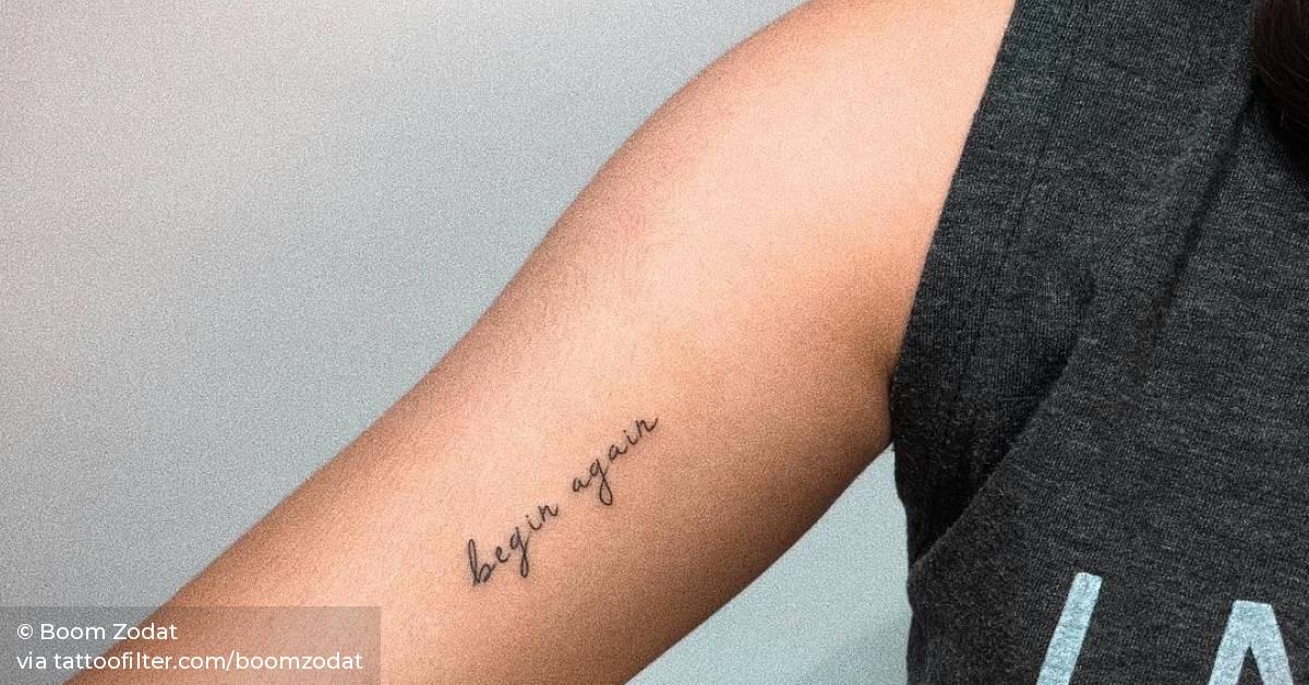 “Begin again” tattoo on the right inner arm.