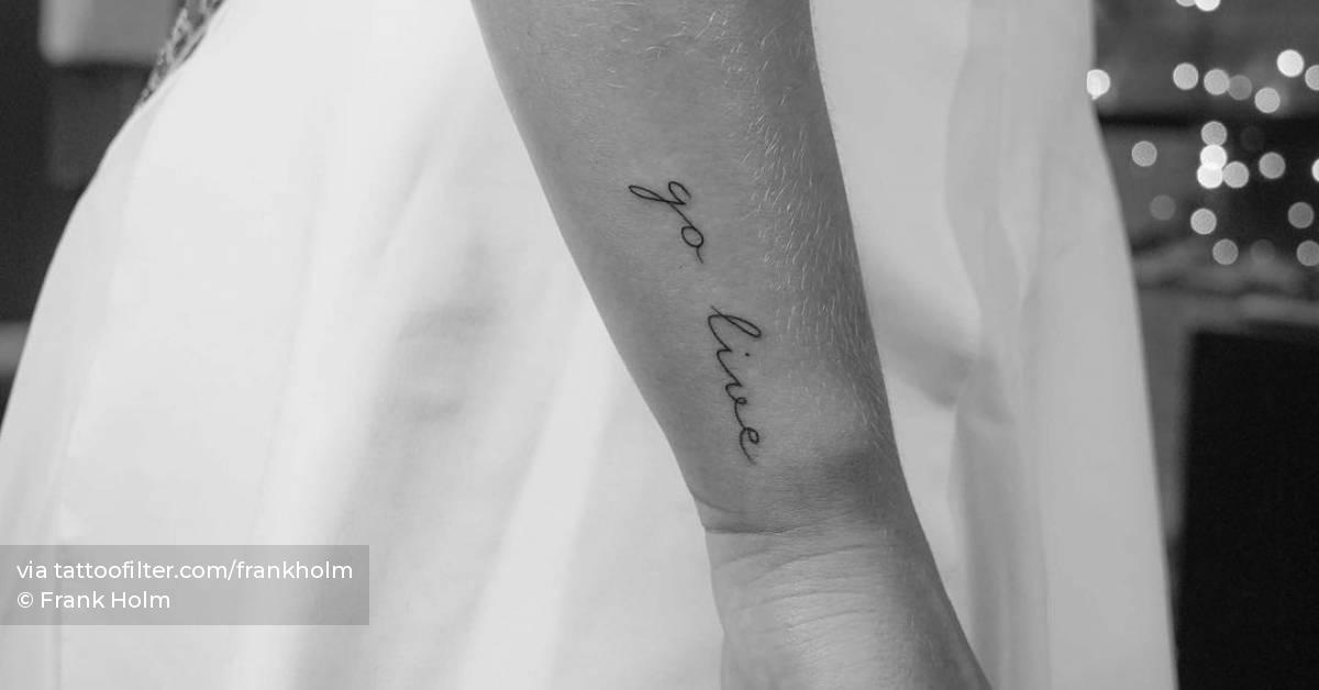 "Go live" lettering tattoo on the wrist.