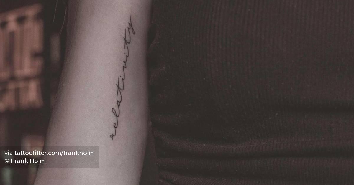 "Relativity" lettering tattoo on the inner arm.