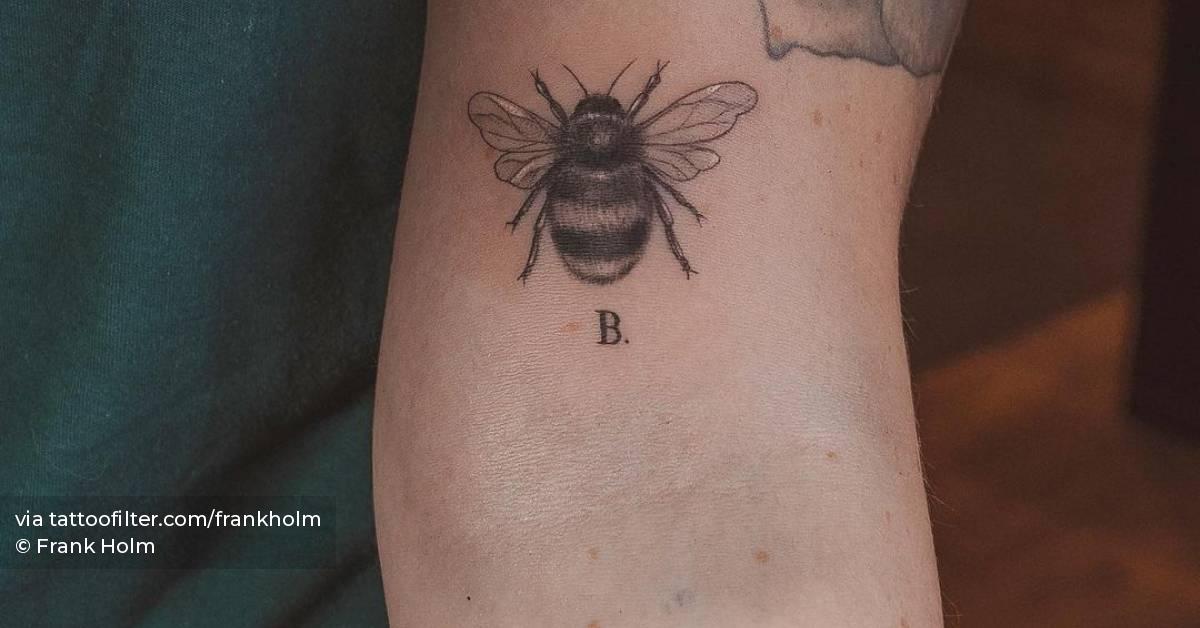 Bee tattoo on the bicep.