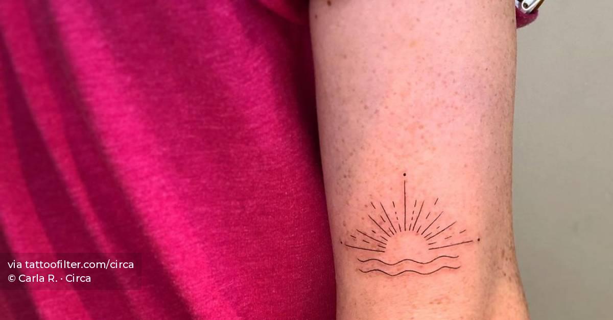 Fine line sunset tattoo on the tricep.