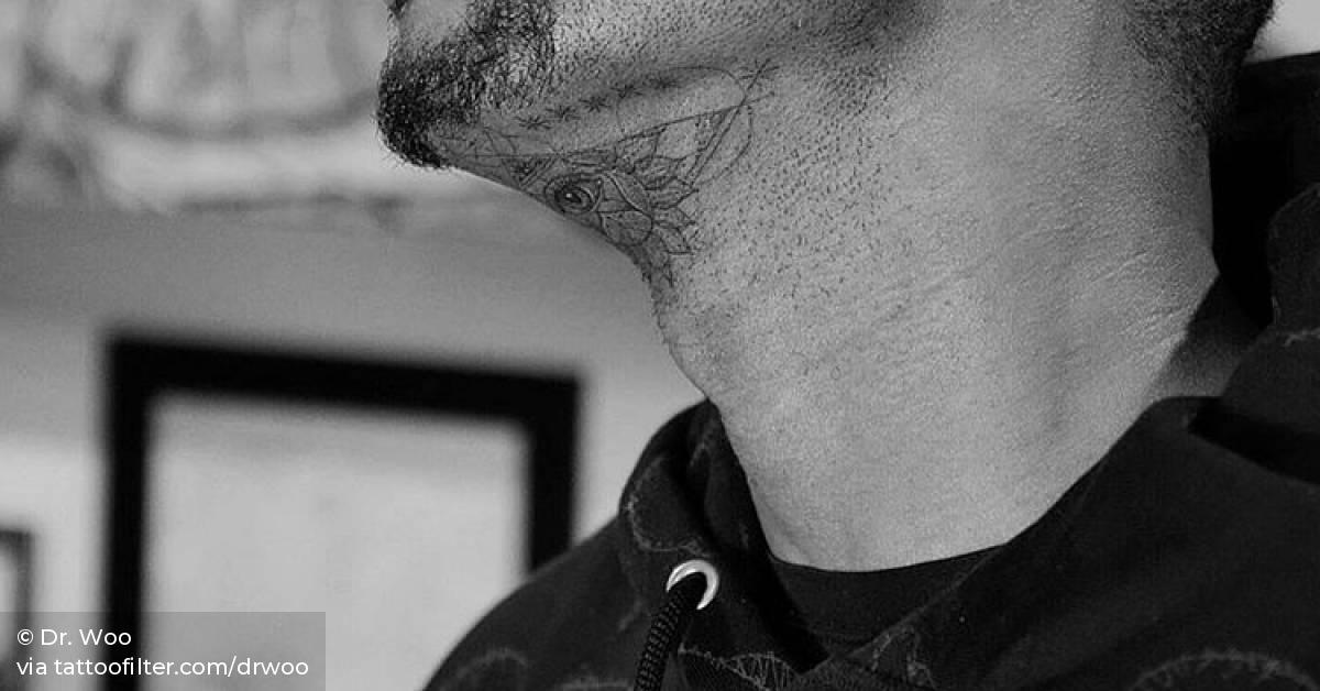 Usher's mystical tattoo on his throat featuring a lotus