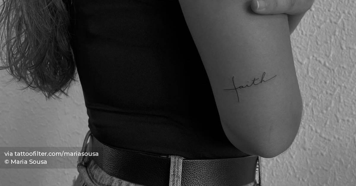 "Faith" lettering tattoo on the tricep.