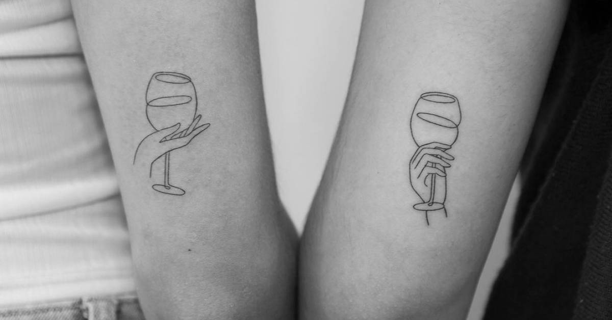 Fine line matching wine glass tattoos for best friends.
