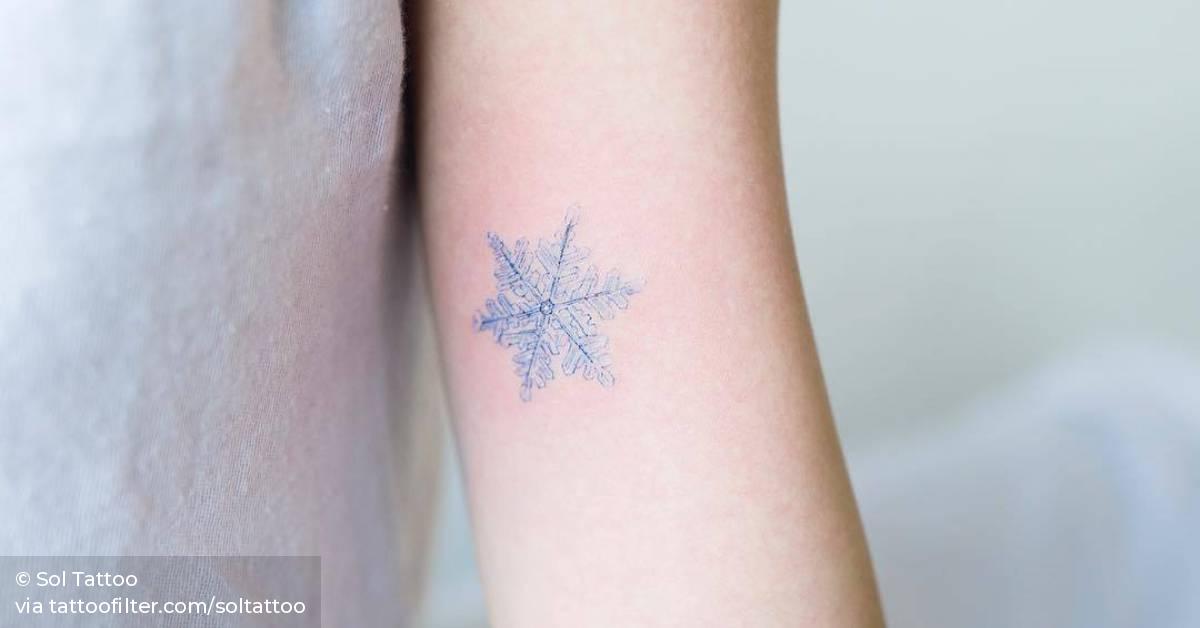 Snowflake tattoo on the left arm.