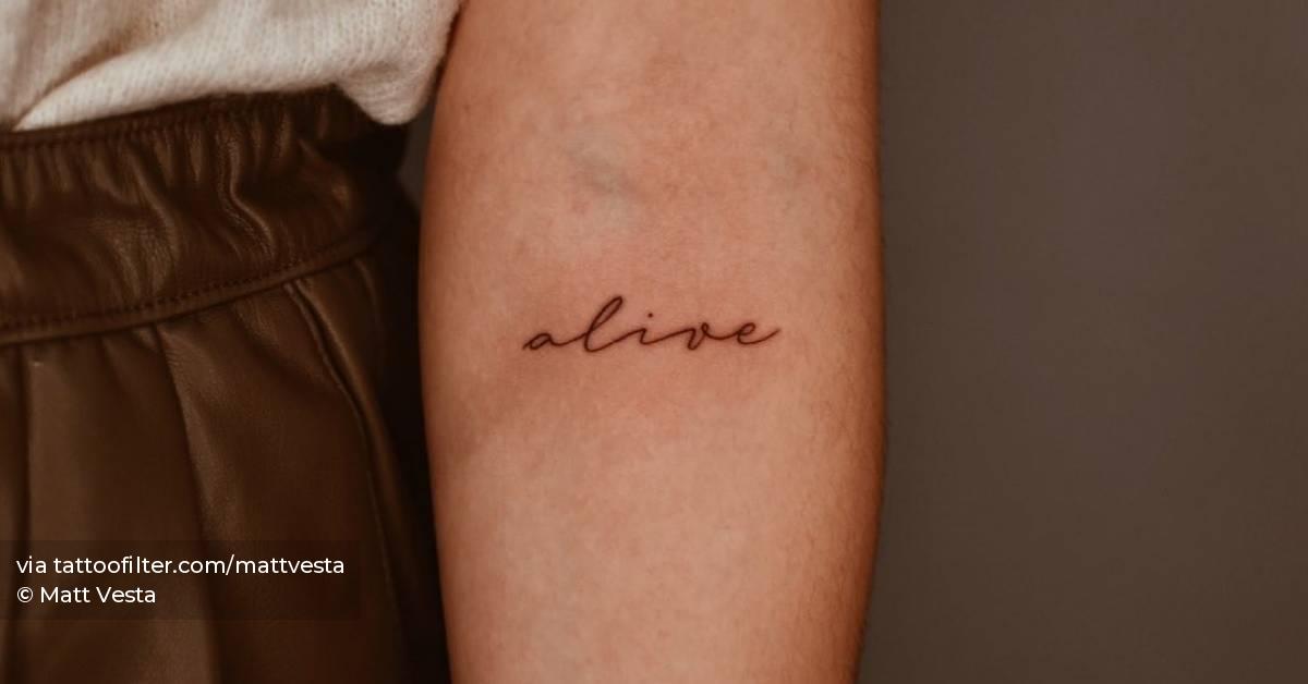 "Alive" lettering tattoo on the inner forearm.