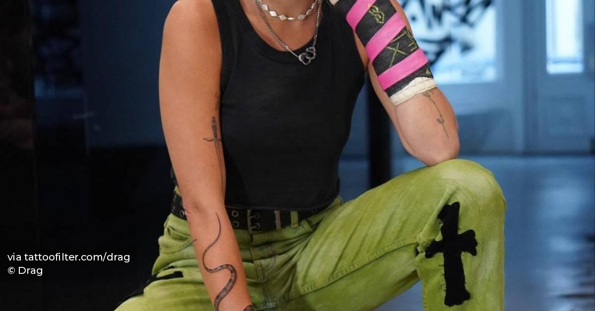 Micro-realistic snake tattoo on GG Magree's forearm.