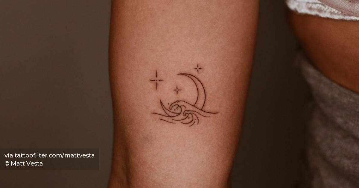 Minimalist moon and wave tattoo on the inner arm.