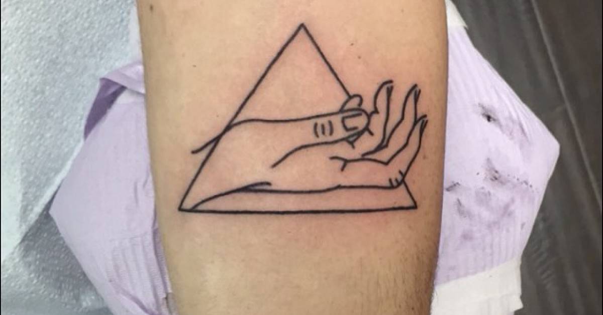 Minimalist hand tattoo on the left inner forearm.
