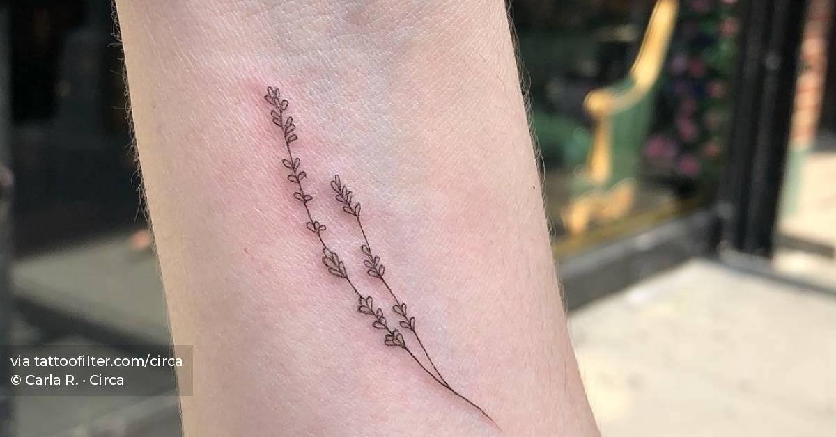 Fine line lavender tattoo on the wrist.