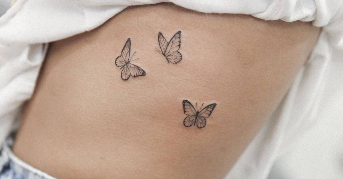 Fine line butterflies tattoo on the rib.