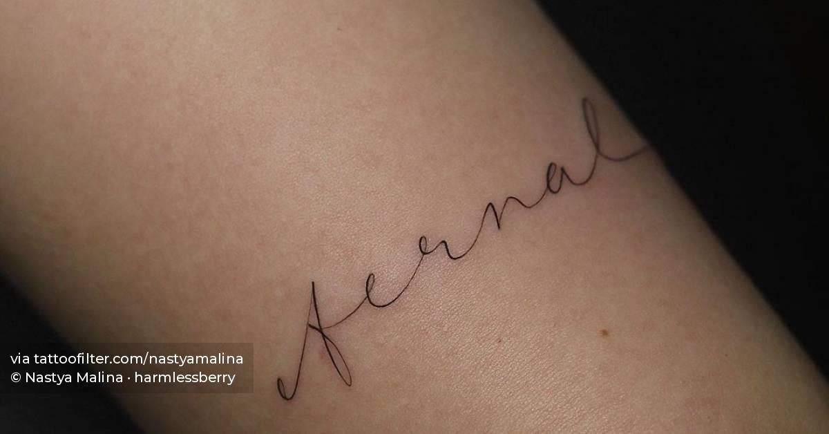 "Eternal" lettering tattoo on the tricep.