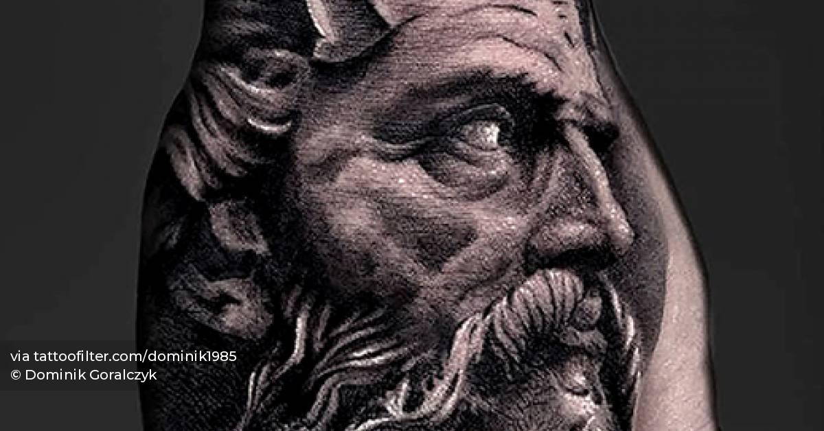 Bust of Neptune tattoo located on the hand.