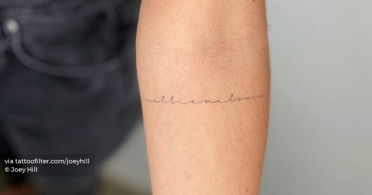 Lettering tattoo on the inner forearm (healed).