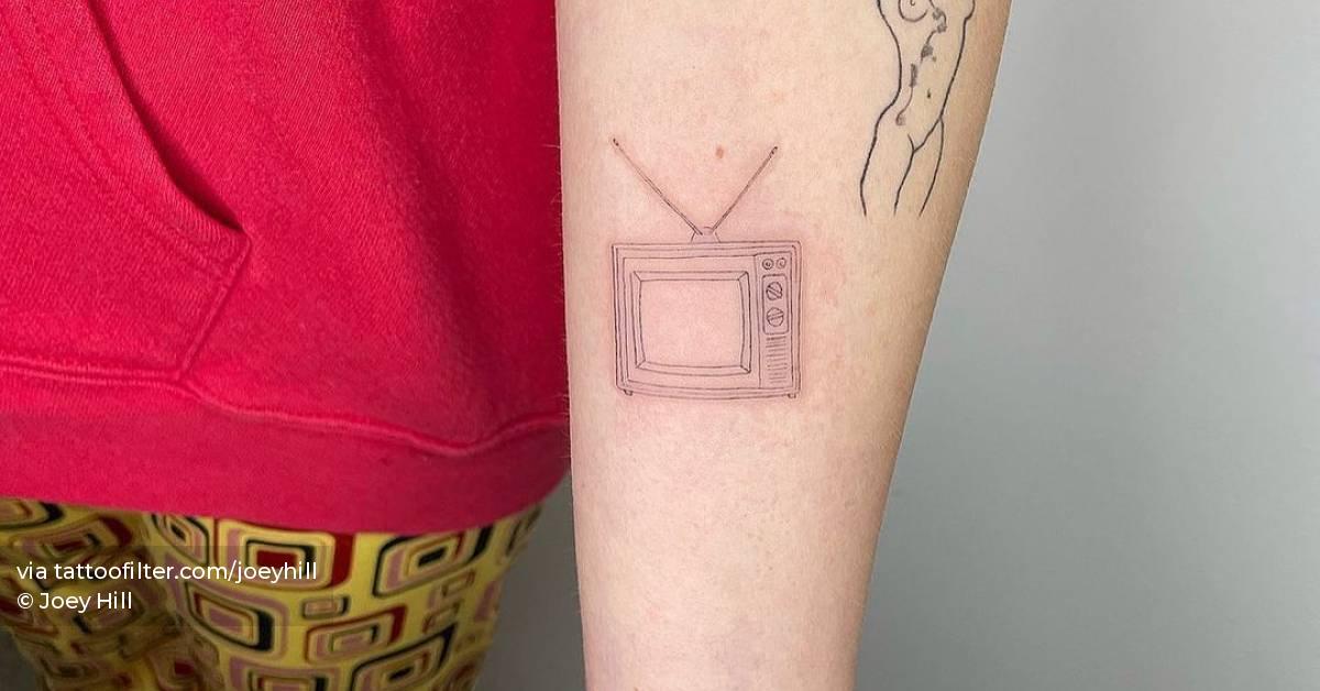 Single needle TV tattoo on the inner forearm.