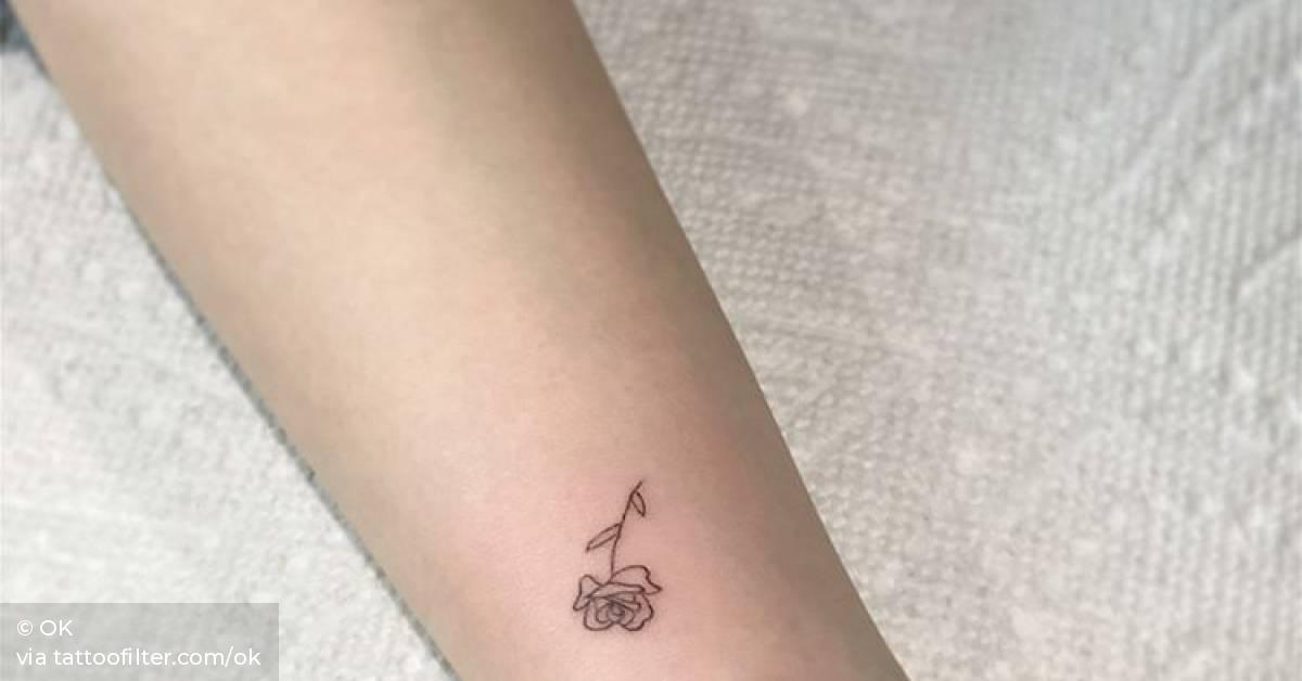 Fine line rose tattoo on the wrist.