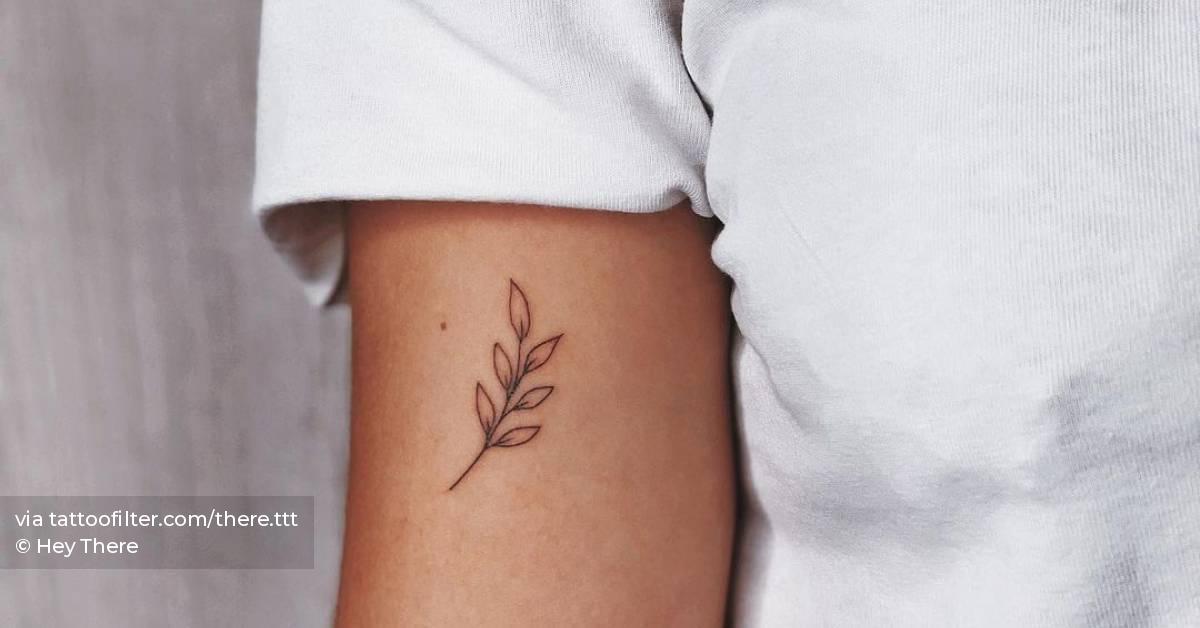 FIne line sprig tattoo on the inner arm.
