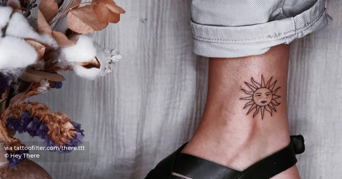 Line art sun tattoo on the ankle.