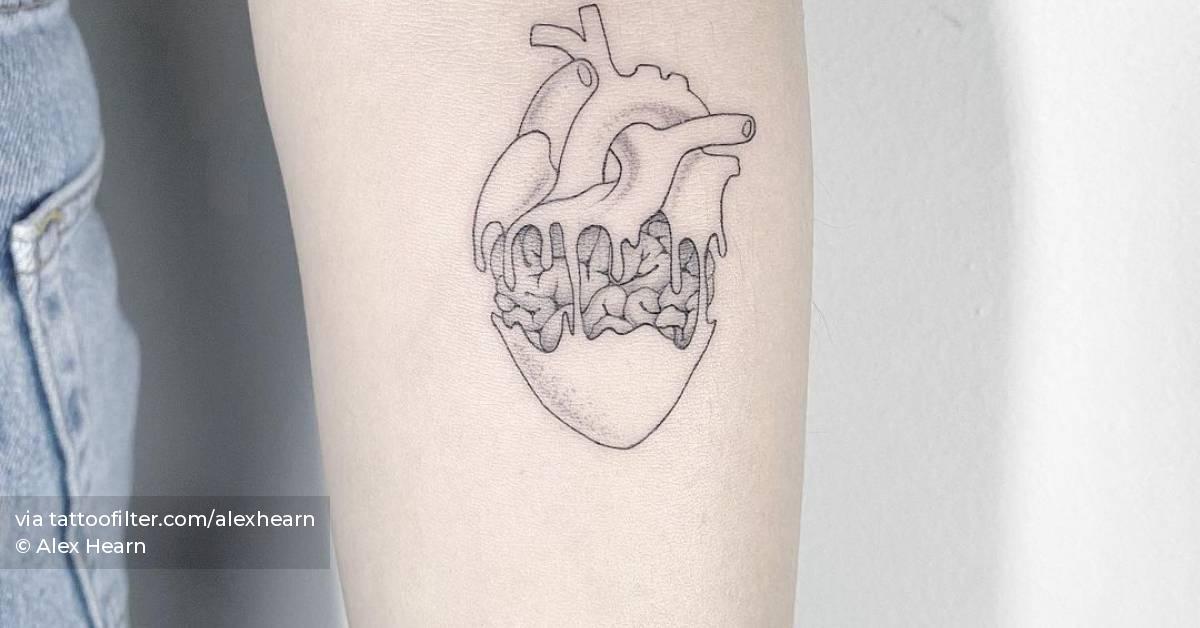Fine line heart vs. brain tattoo on the inner forearm.