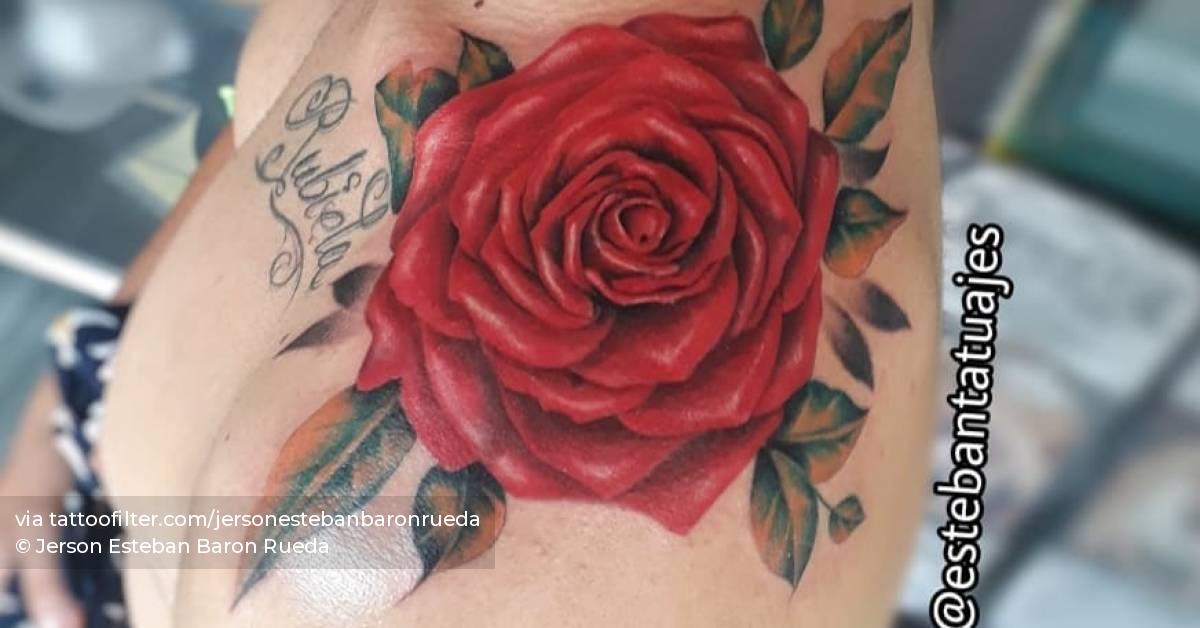 Realistic rose head tattoo on the shoulder.