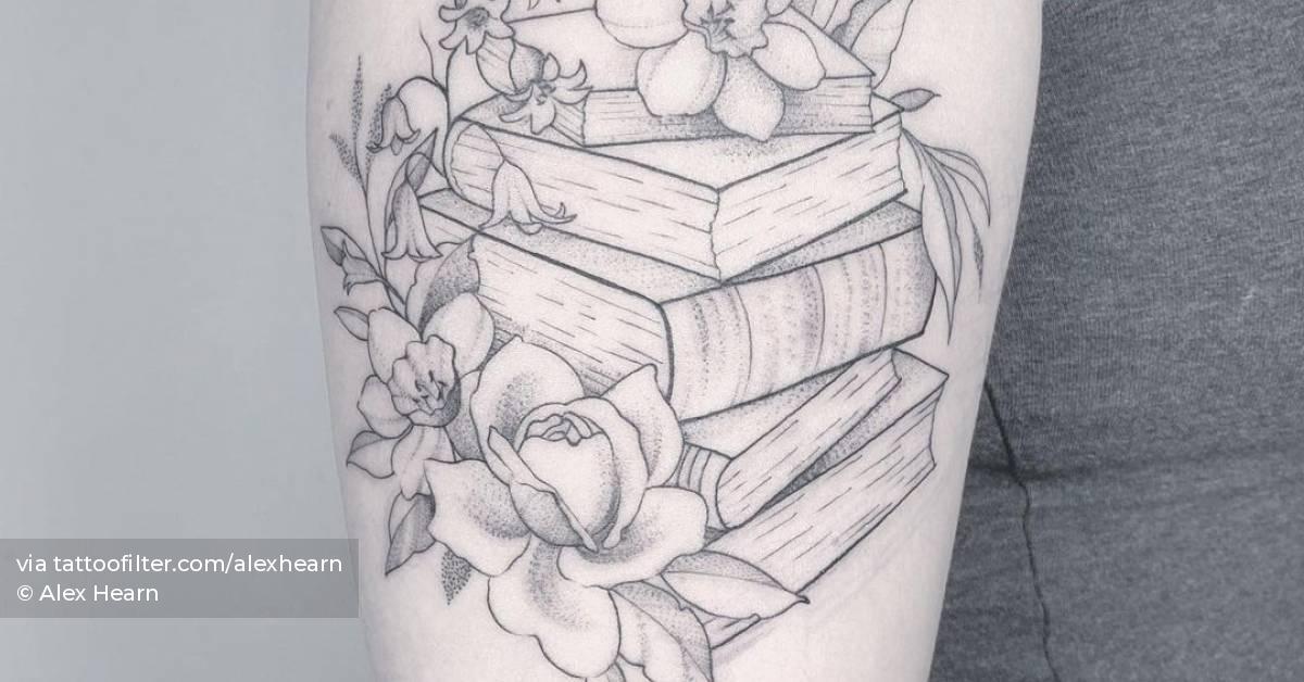 Fine line books and flowers tattoo on the upper arm.