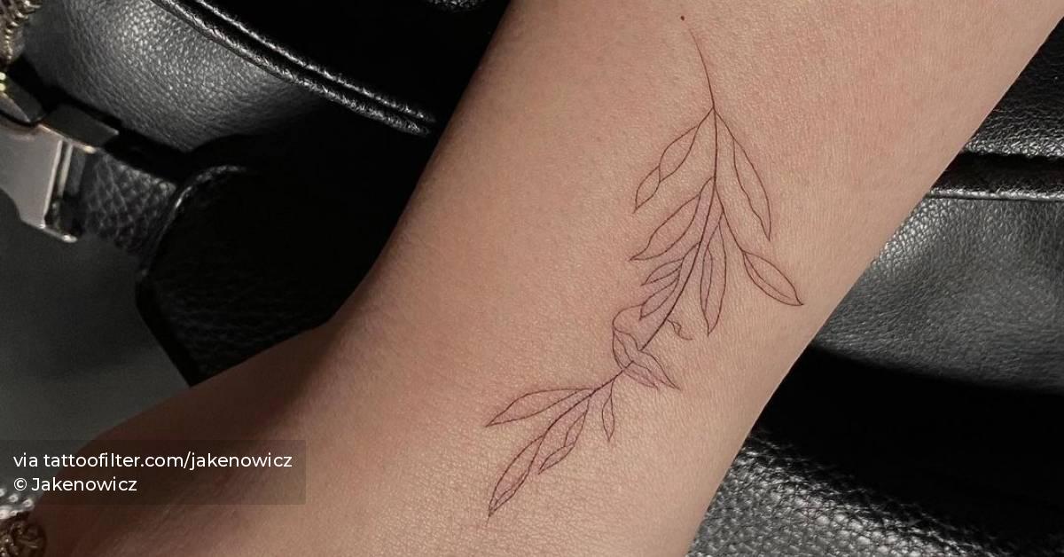 Single needle leaves tattoo on the wrist.