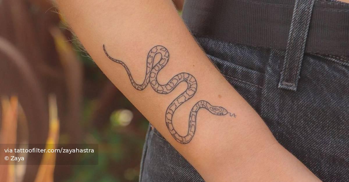 Fine line snake tattoo on the wrist.