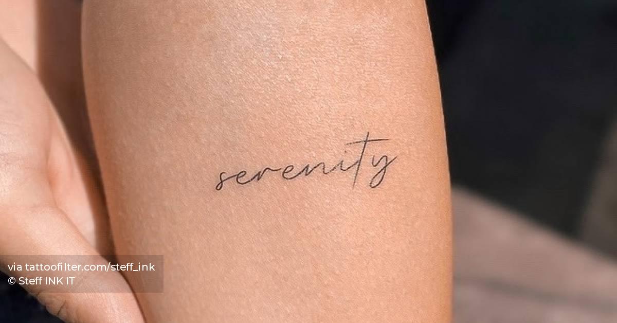 "Serenity" lettering tattoo on the inner forearm.