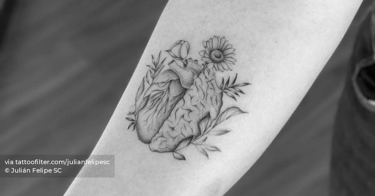 FIne line heart vs. brain tattoo on the inner forearm.