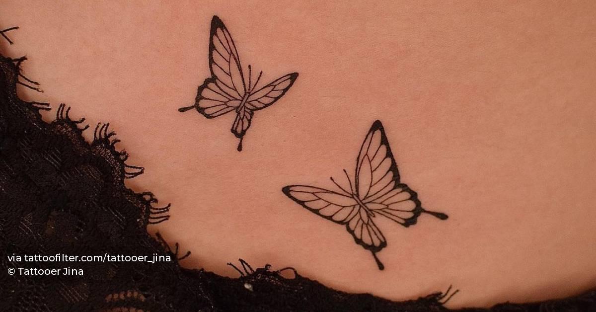 Fine line butterflies tattooed on the rib