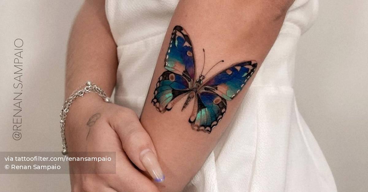 Blue butterfly tattoo on the forearm.