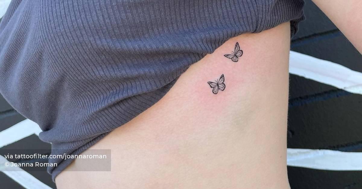 Fine line butterflies tattoo on the rib.