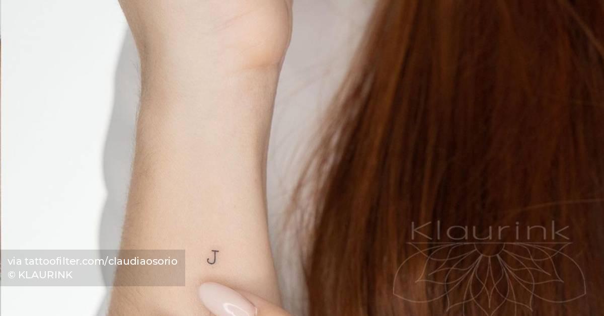 "J" lettering tattoo on the wrist