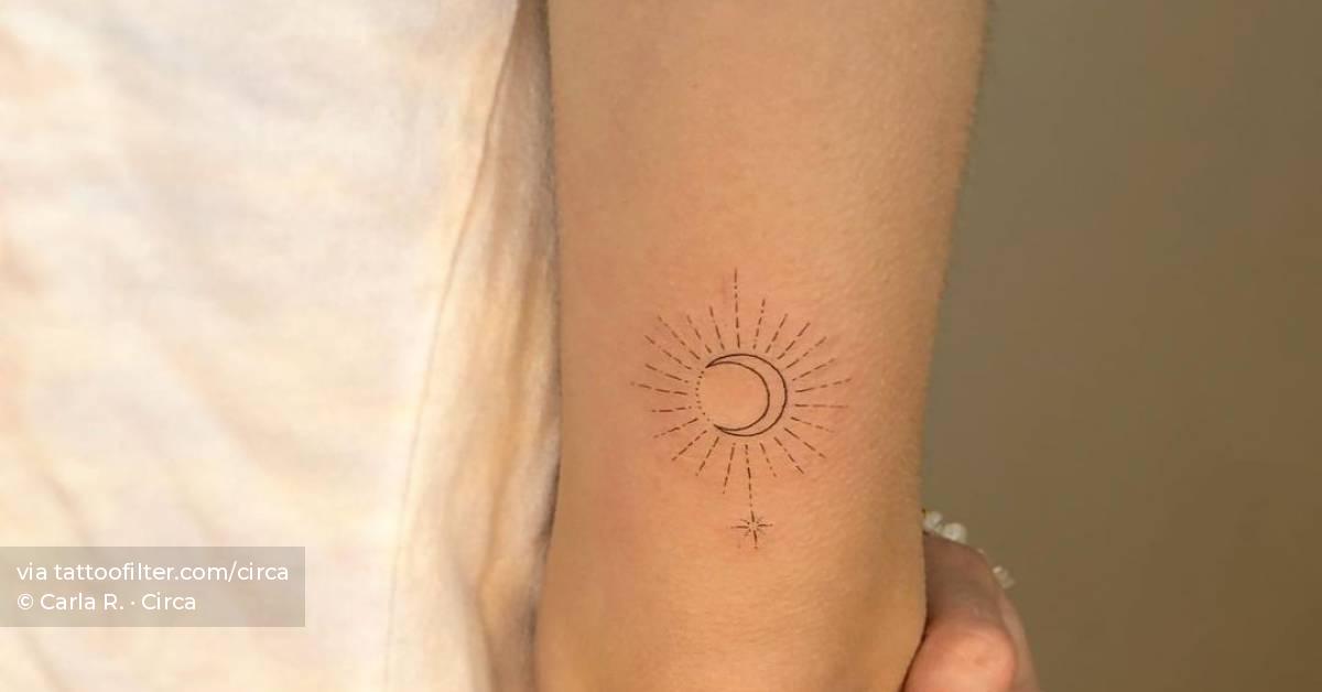 Fine line sun and moon tattoo on the tricep.
