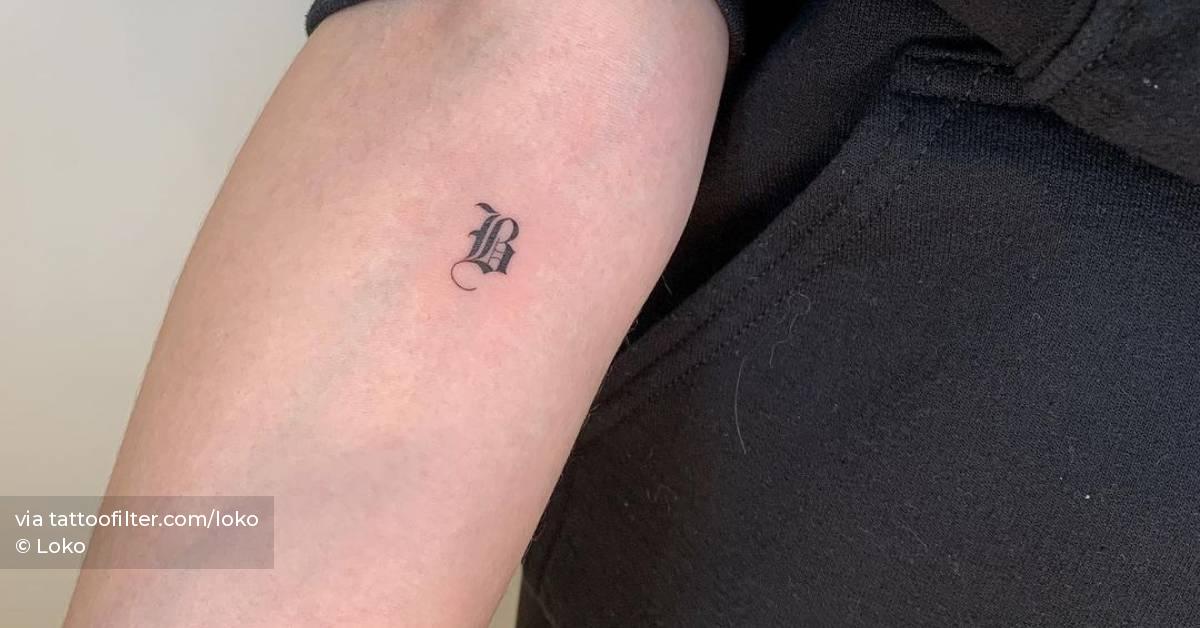 Letter "B" tattoo on the inner forearm.
