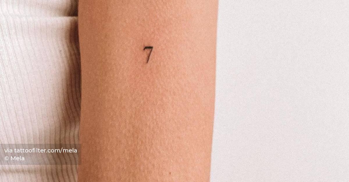 Number "7" tattoo on the tricep.