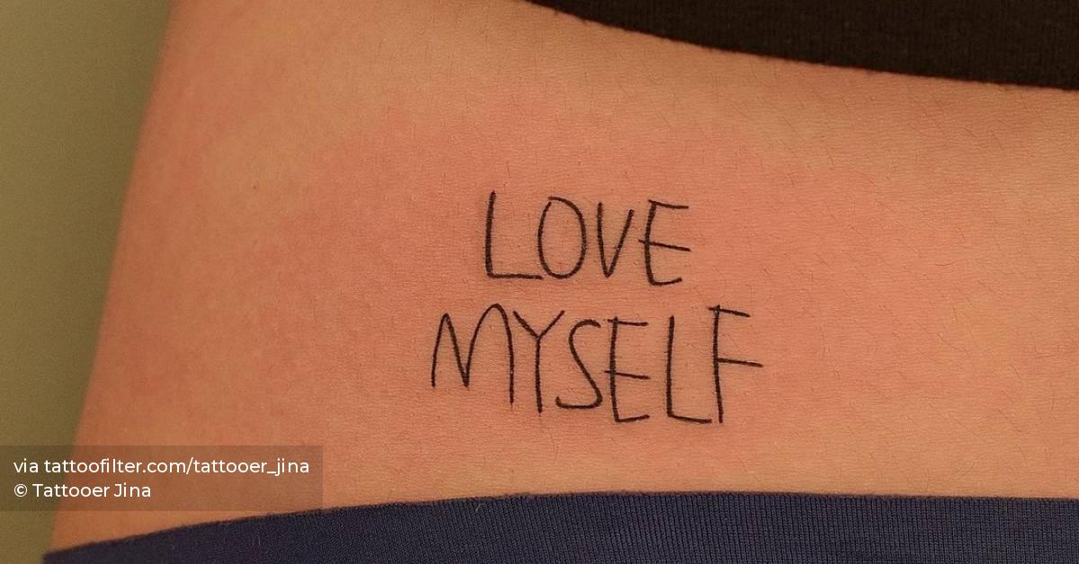 "Love myself" lettering tattoo on the lower back.