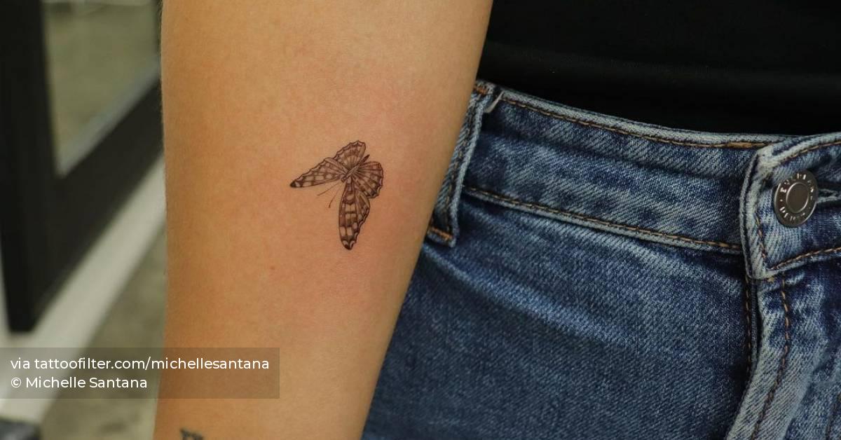Micro-realistic butterfly tattoo on the inner forearm.