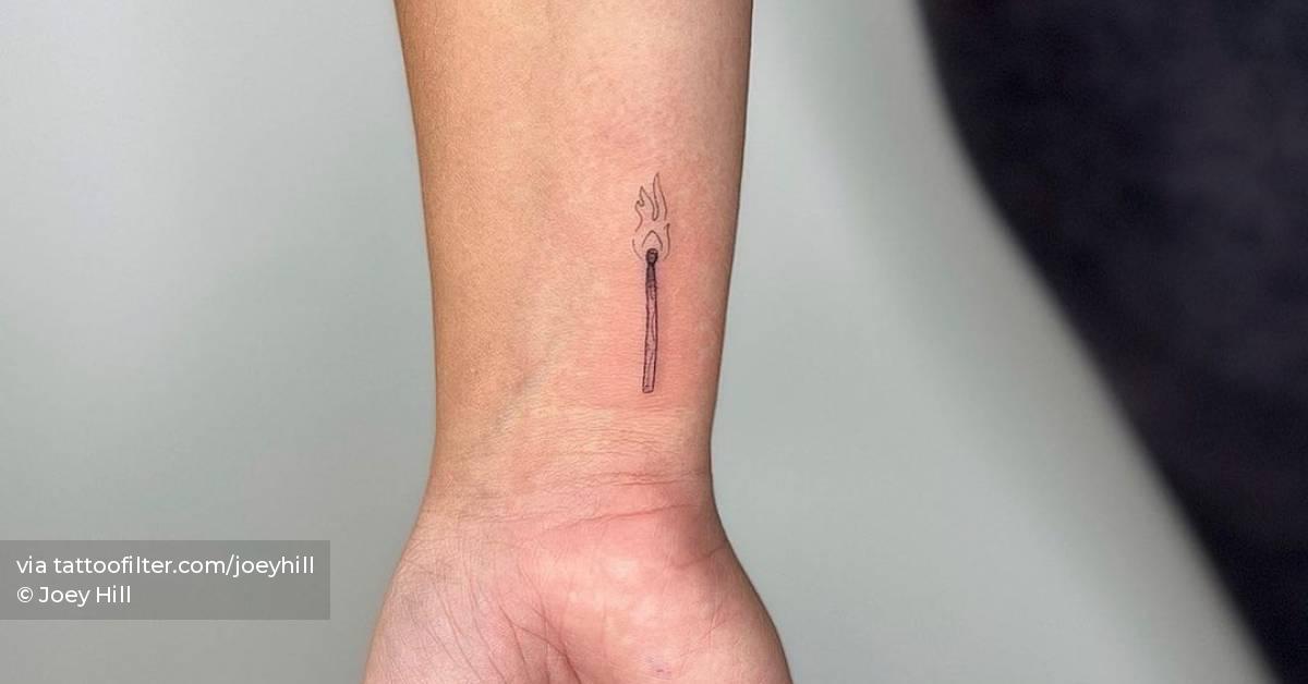 Fine line matchstick tattoo on the wrist.
