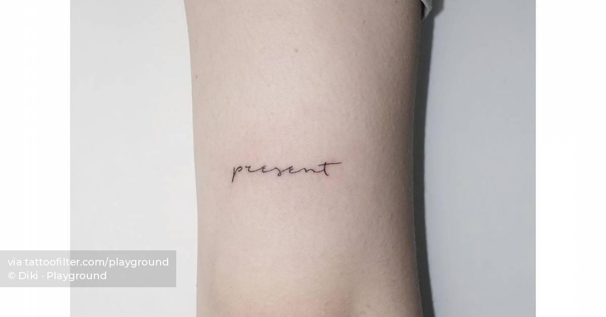 "Present" lettering tattoo on the tricep.
