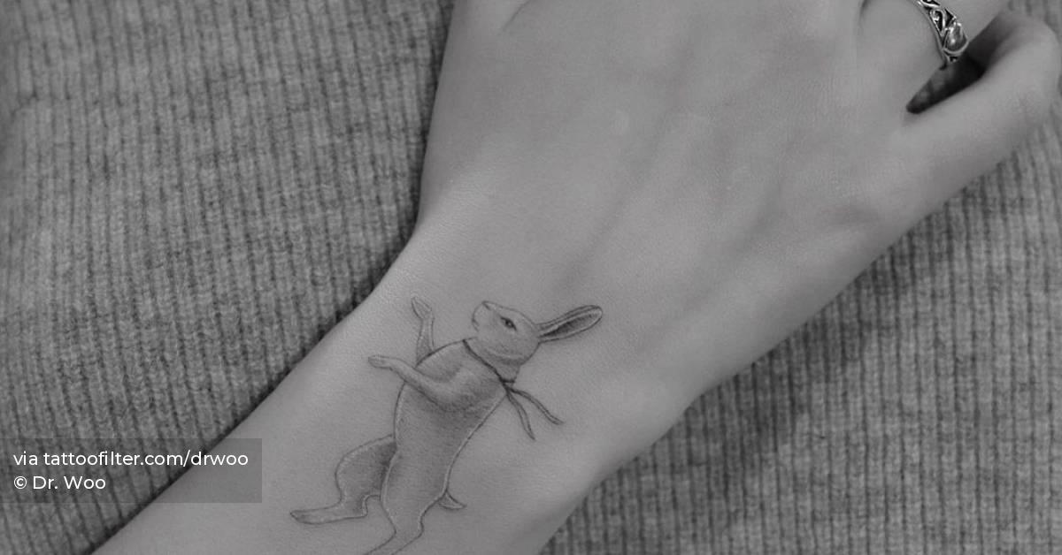Single needle rabbit tattoo on Clairo's wrist
