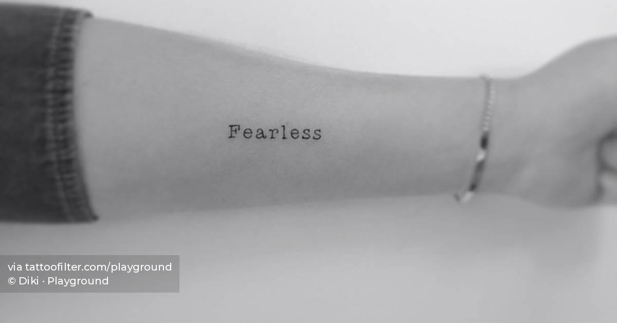 "Fearless" lettering tattoo on the inner forearm.