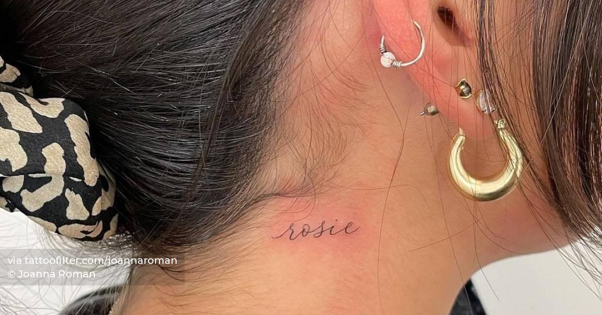 "Rosie" lettering tattoo on the neck.