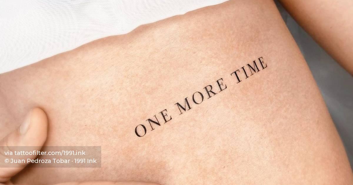 "One more time" lettering tattoo on the rib.