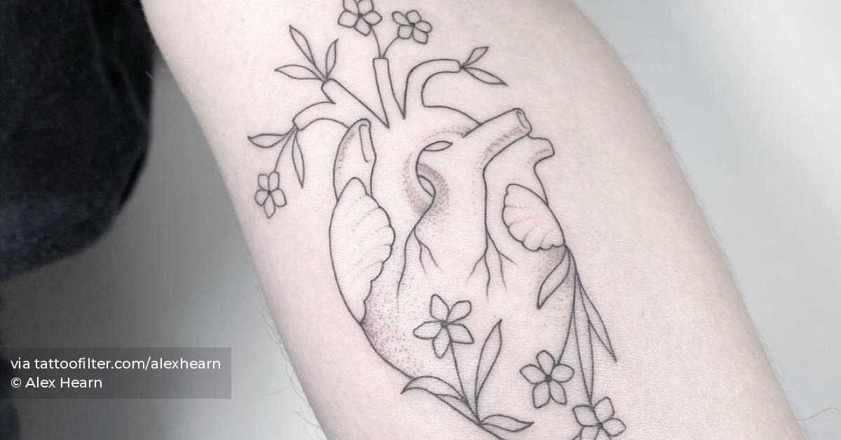 Fine line anatomical heart with flowers tattoo on the