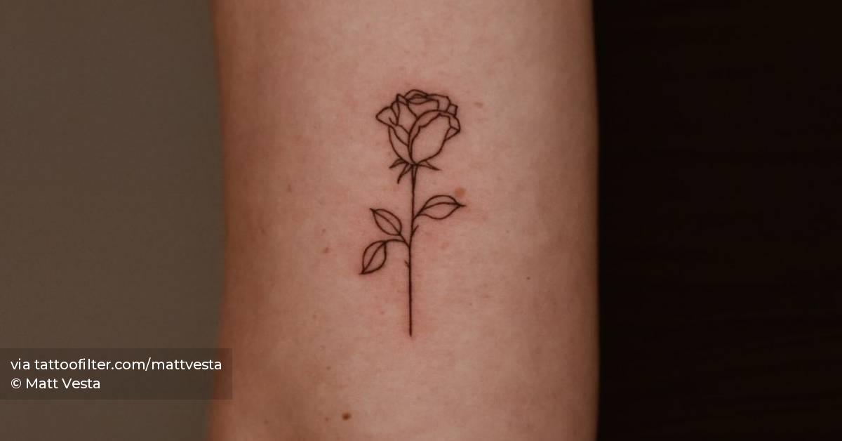 Fine line rose tattoo on the tricep.