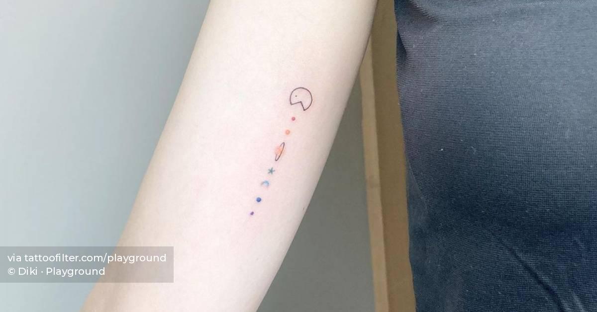 Pac man tattoo on the inner arm.